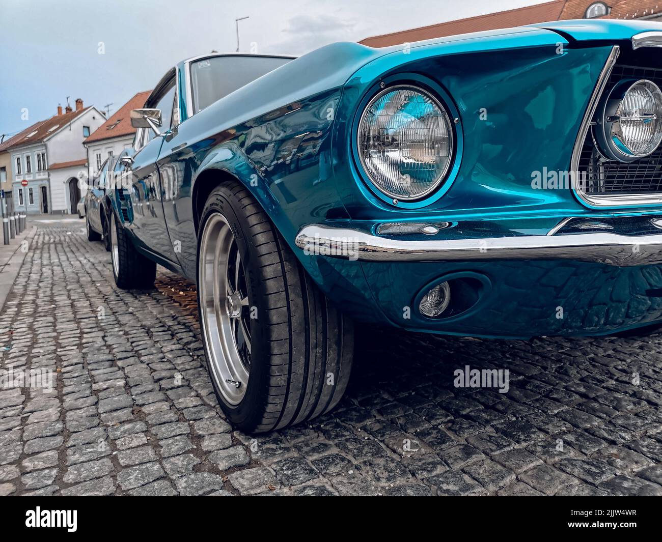 A low angle shot of the front view of a blue Ford mustang gt 390 ...