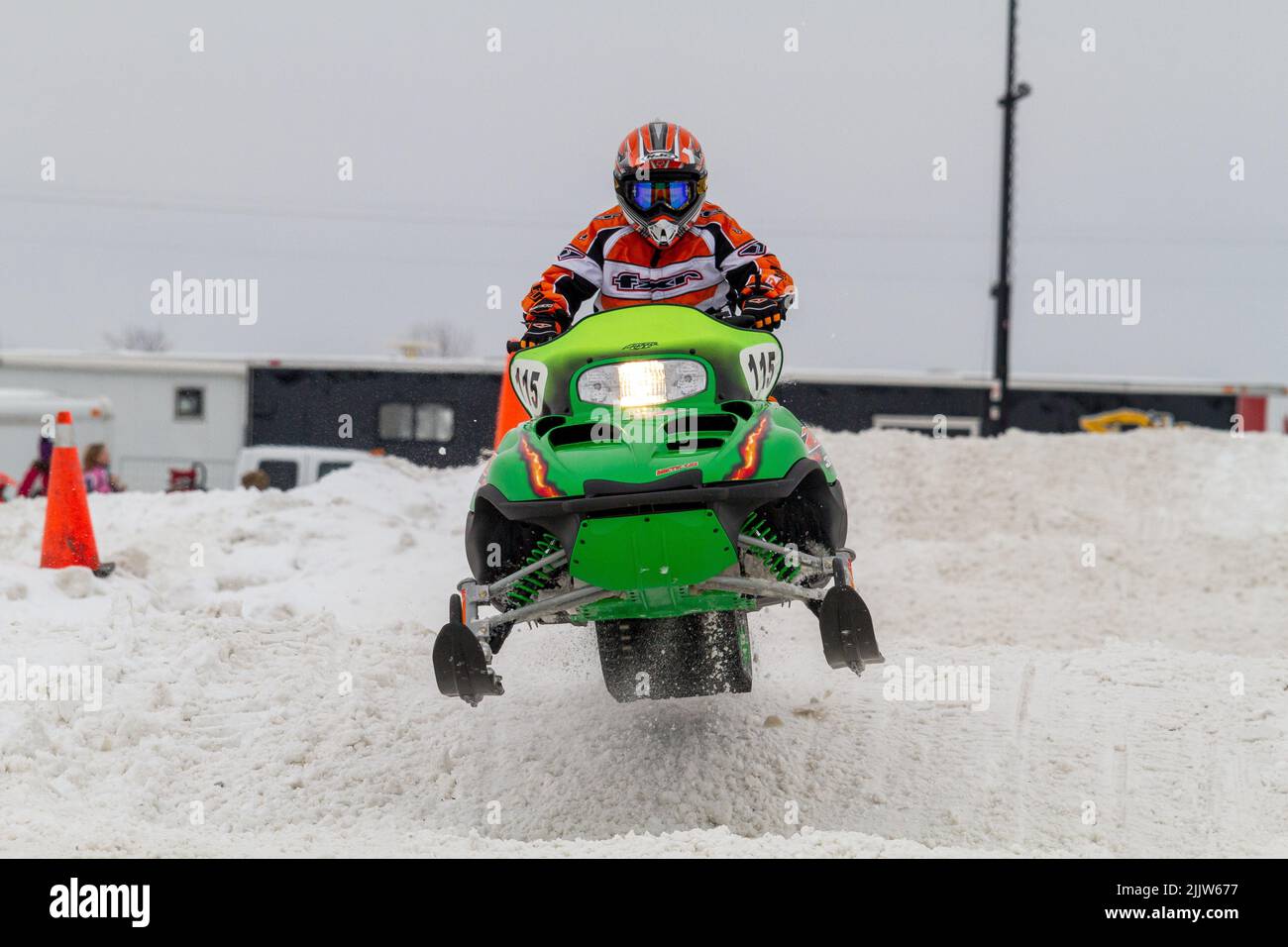 Snowmobiler competing in extreme sports. Snowmobile jumps above the ...