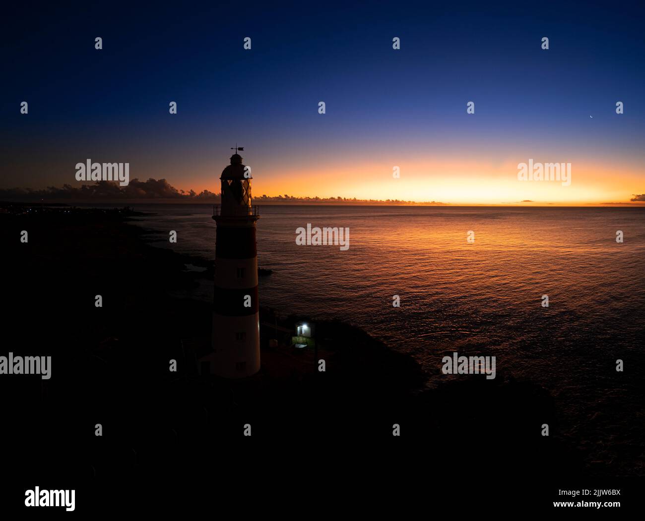 A mesmerizing sunset scenery over a lighthouse in Mauritius Stock Photo ...