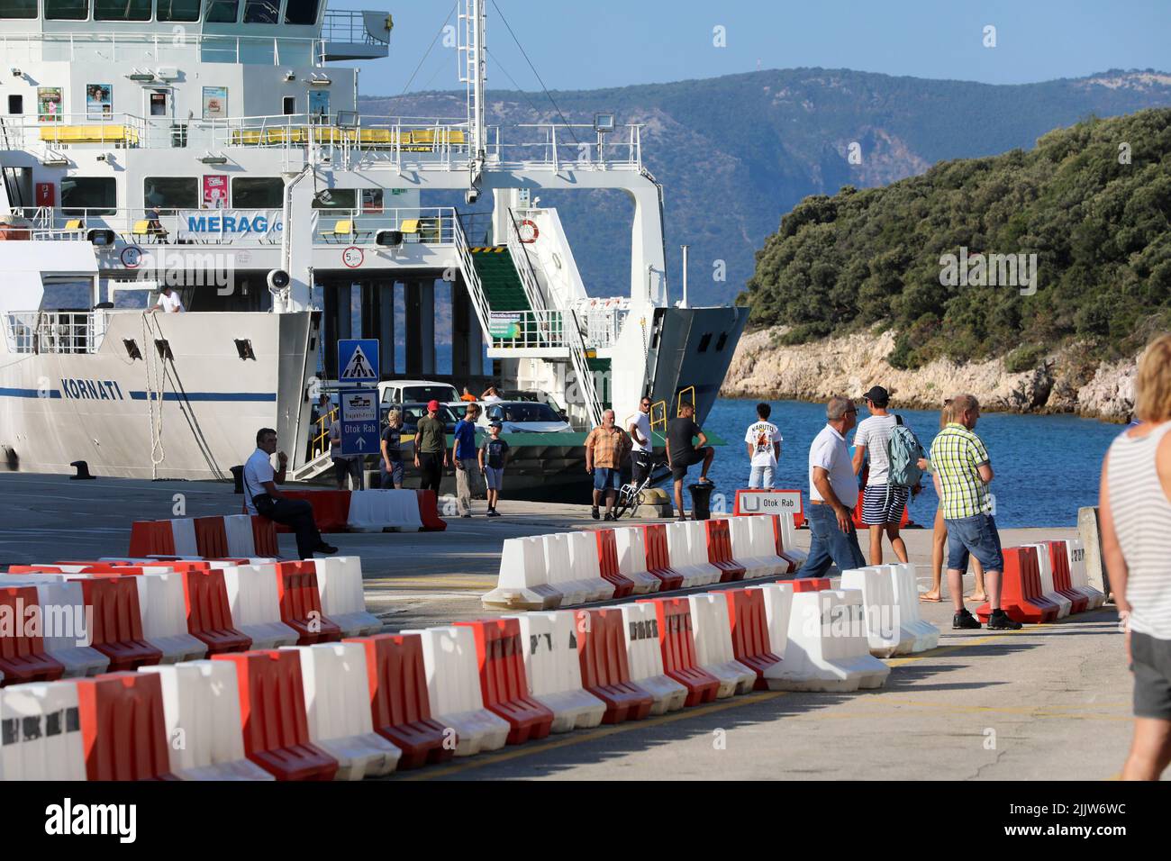 Tourists board the Jadrolinija Kornati and Ilovik ferries at the ...