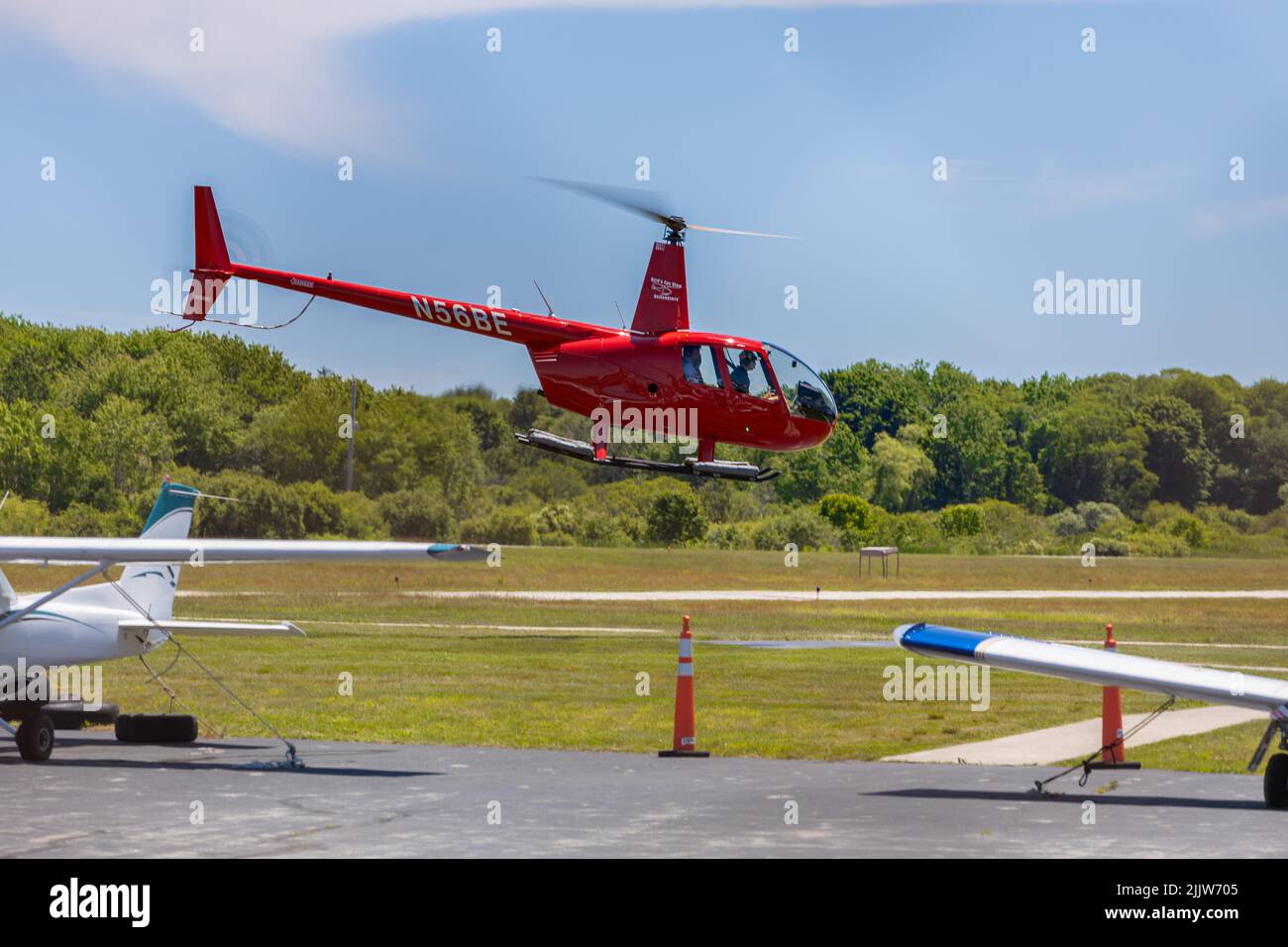 A red helicopter taking off at an airport on a sunny morning Stock ...