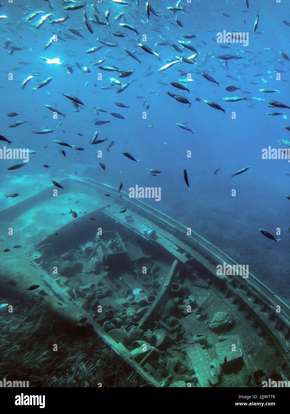 A vertical shot of an old sunk ship on the bottom of the sea with ...