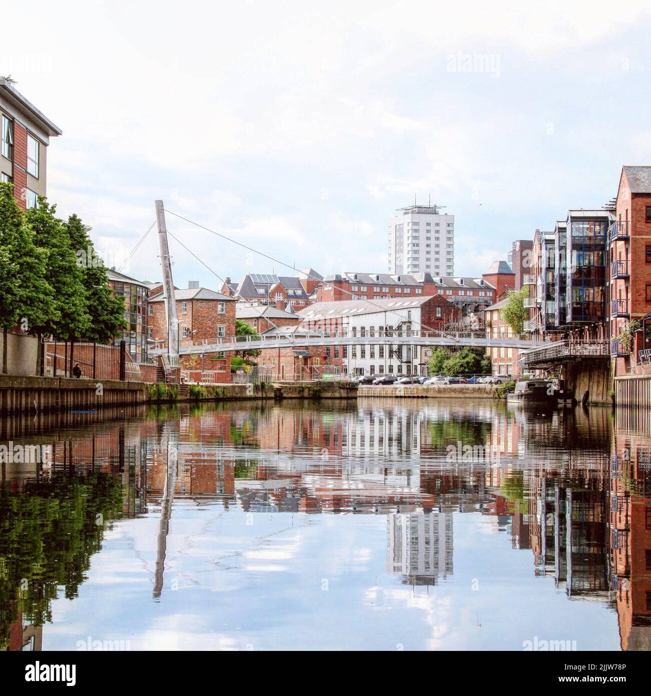 The city buildings reflected in the river Stock Photo - Alamy