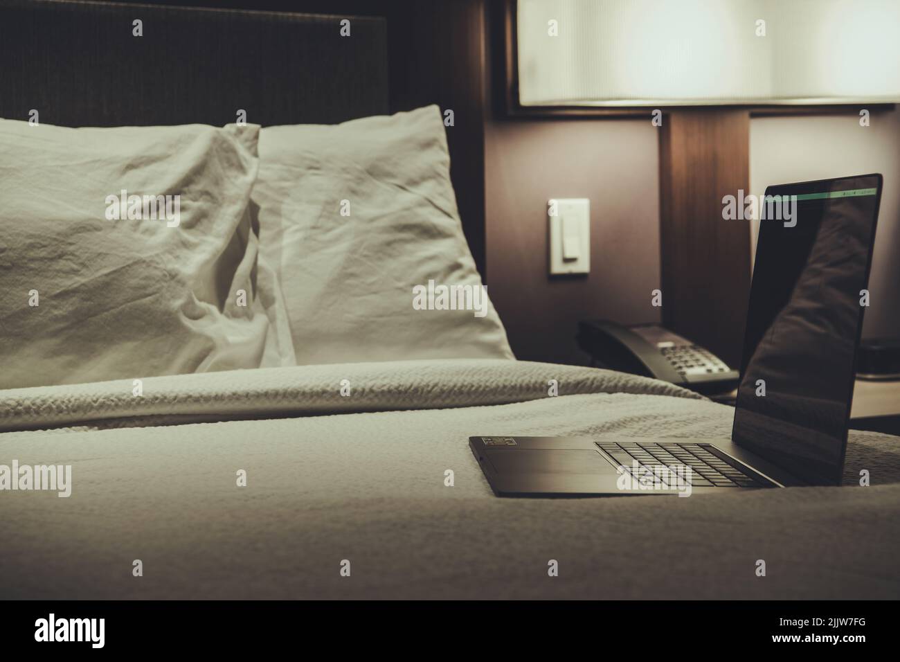 Modern Laptop Computer on a Hotel Bed. Spending Time on the Internet ...