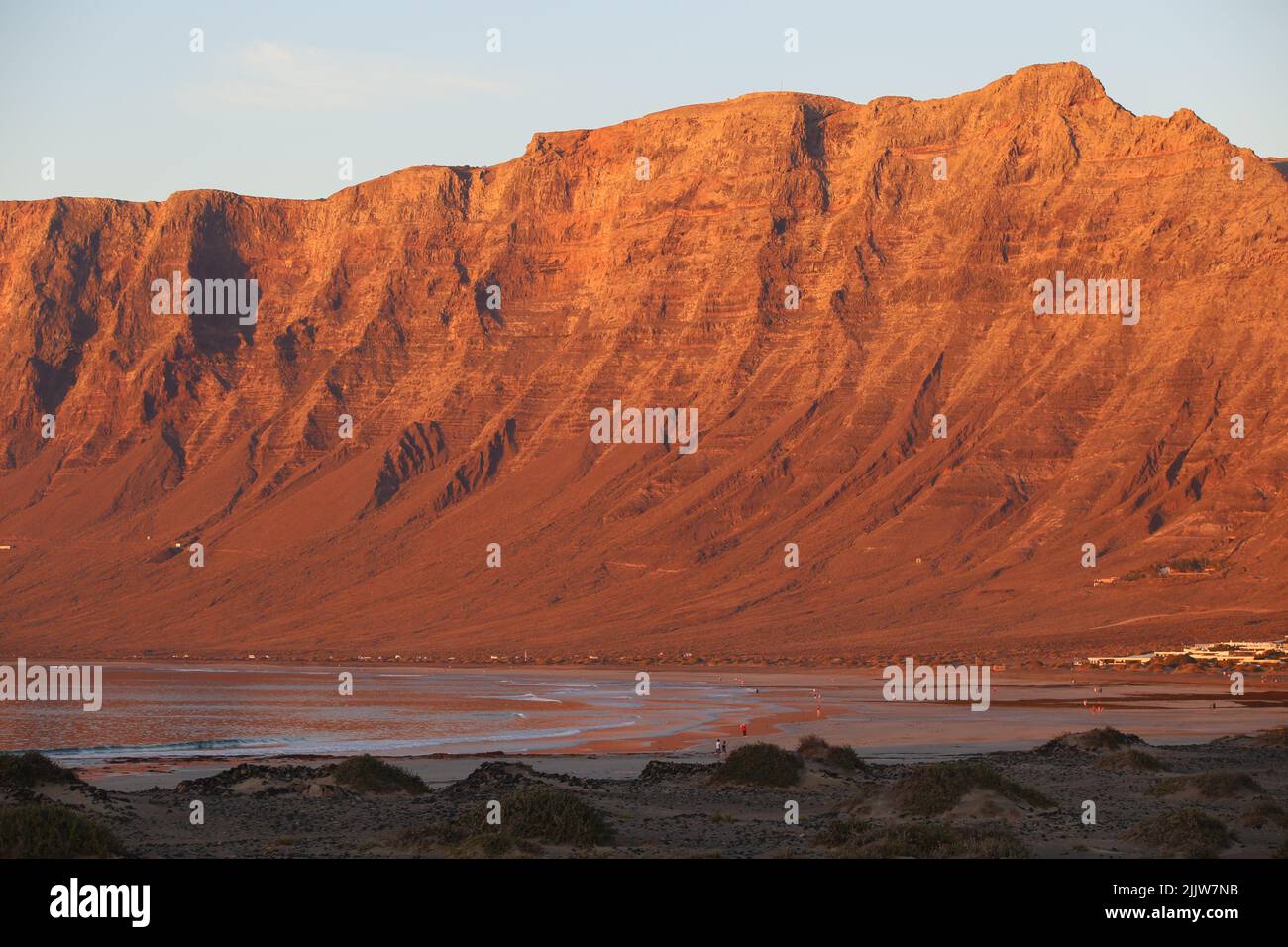 Panoramic view of the Risco de Famara from the beach at sunset Stock ...