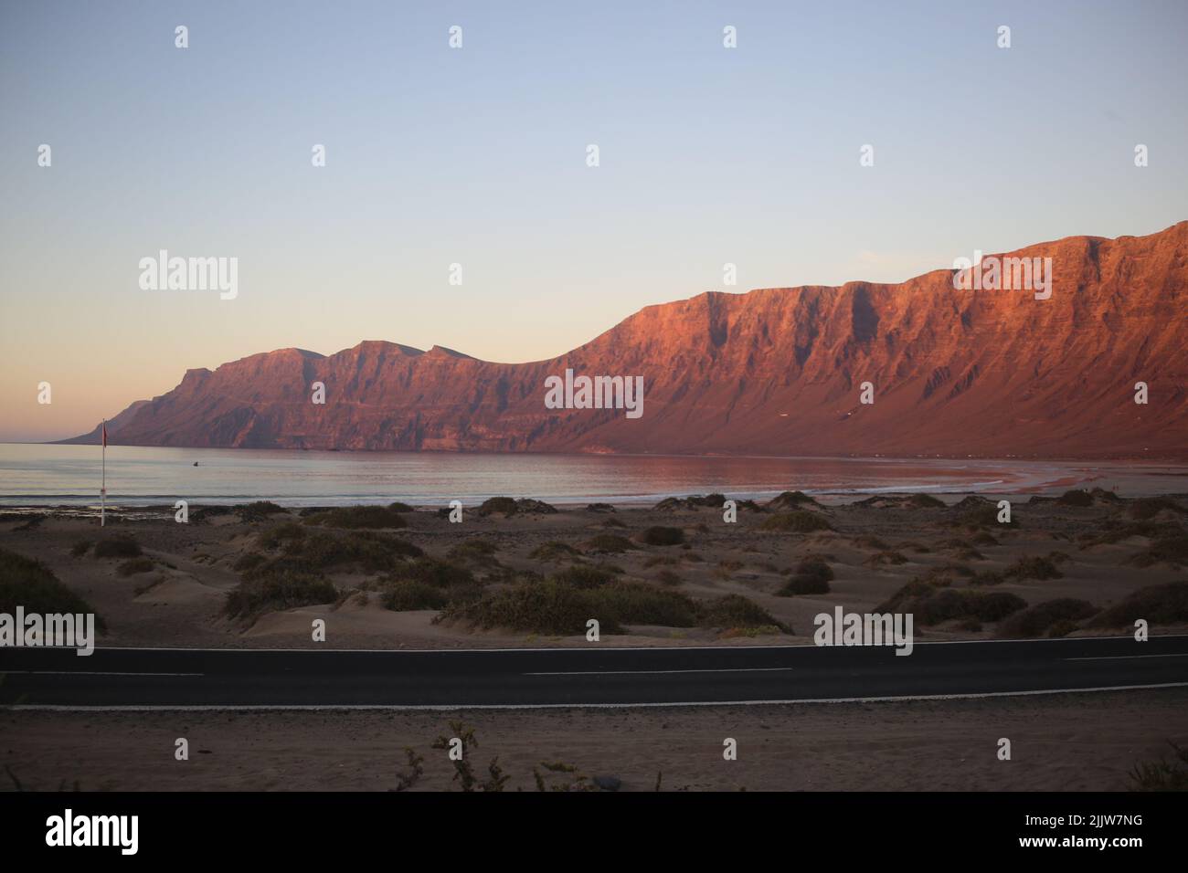 Panoramic view of the Risco de Famara from the beach at sunset Stock ...