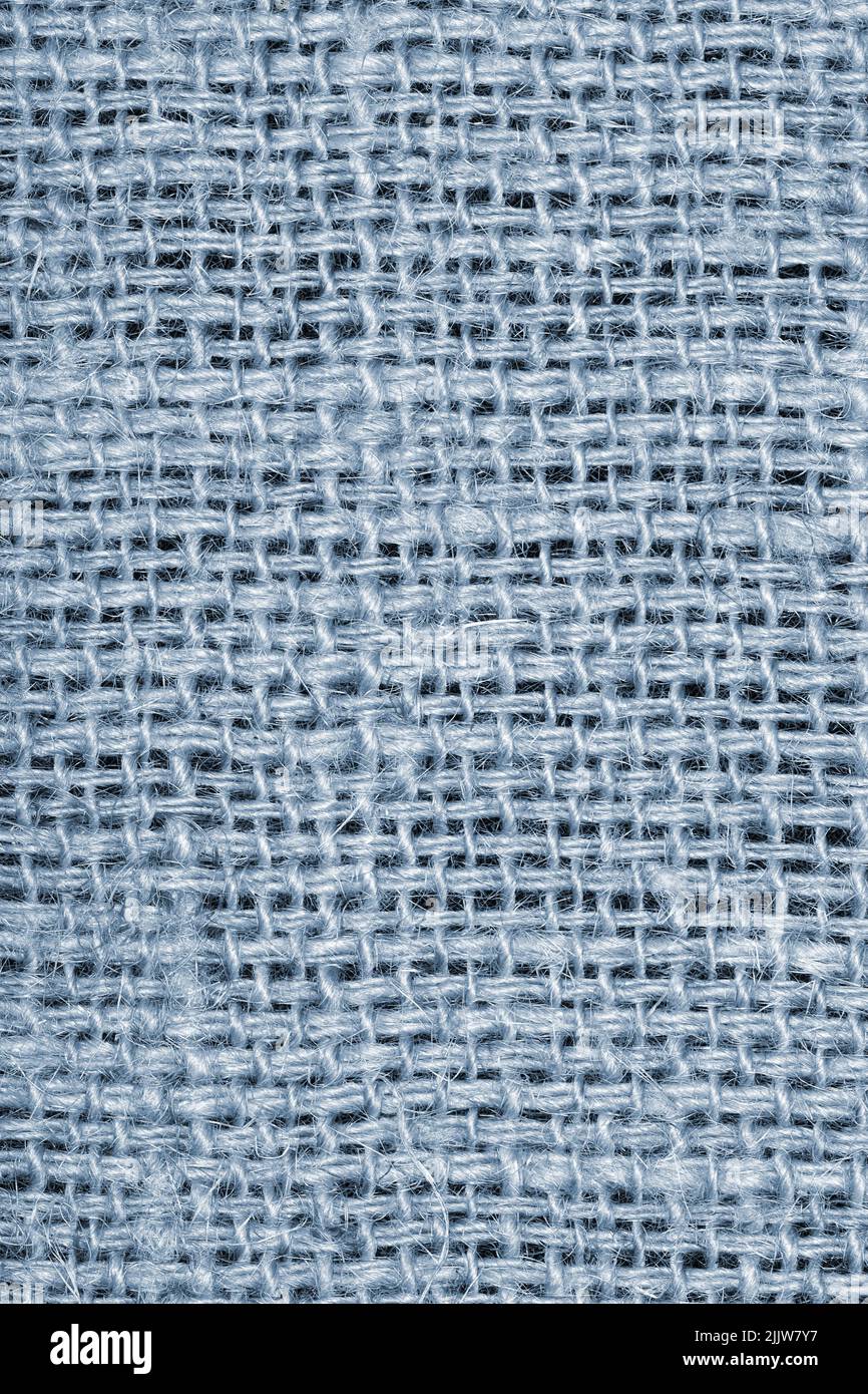 Closeup of burlap hessian sacking. Texture canvas fabric isolated on black background. Light ...