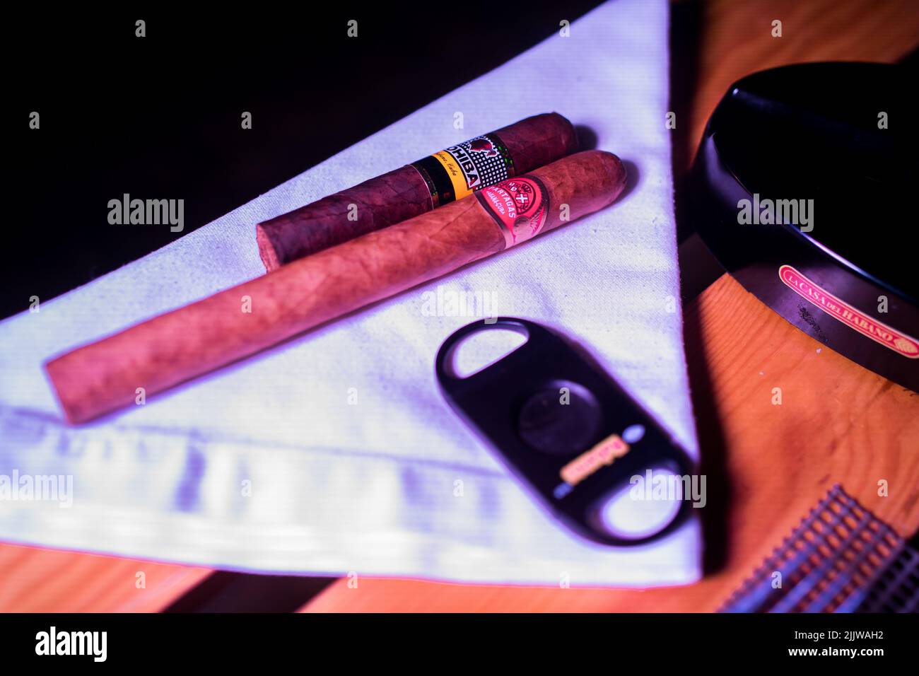 Closeup photo of many cigars on the table with a blue cocktail Stock ...