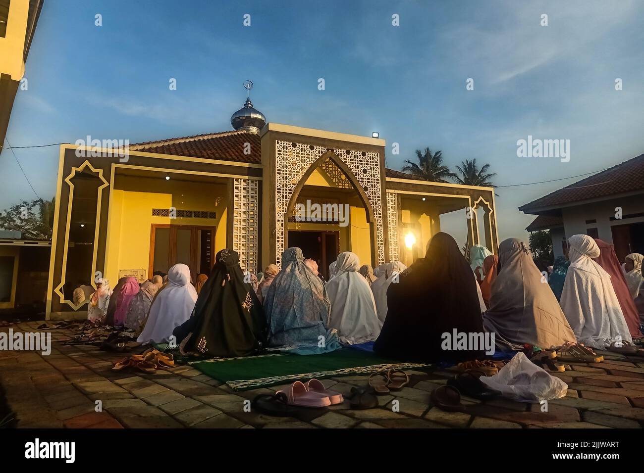A backshot of females they perform the Eid prayer outside a mosque ...
