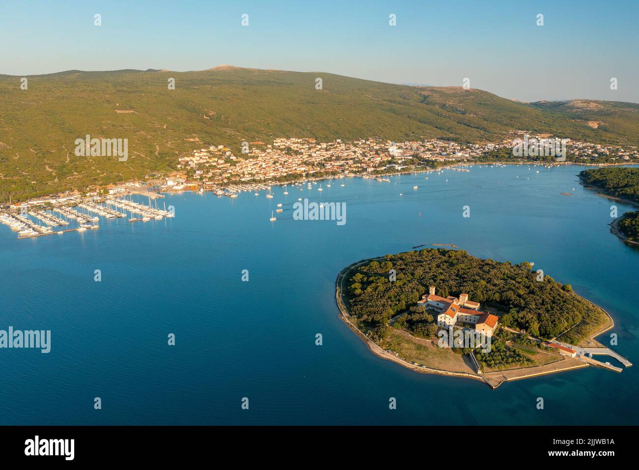 Aerial view of Kosljun monastery with Punat town in the background, Krk ...