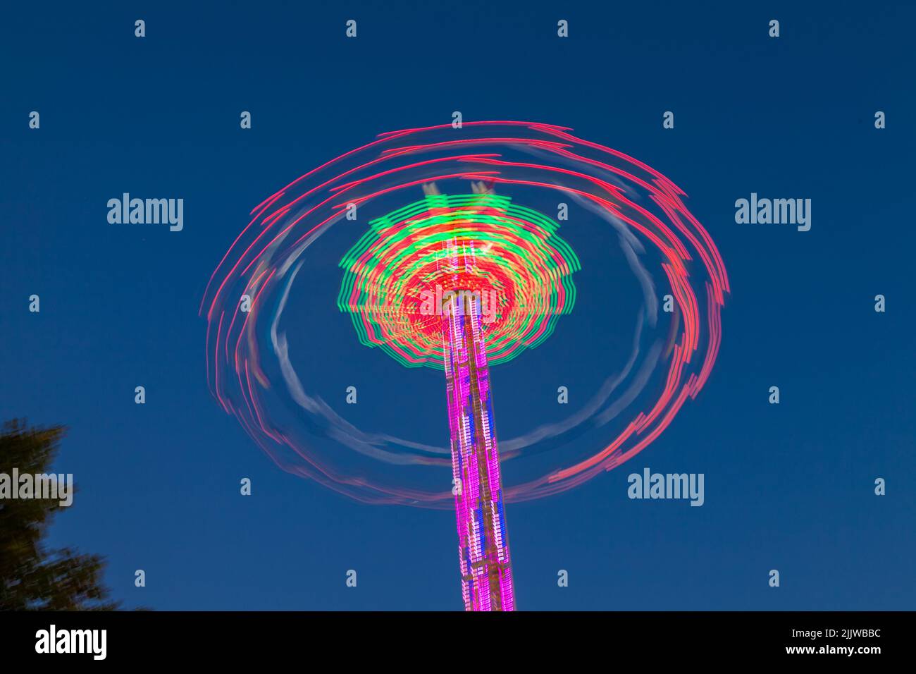 A rotating carousel with colorful lights in amusement park Stock Photo ...