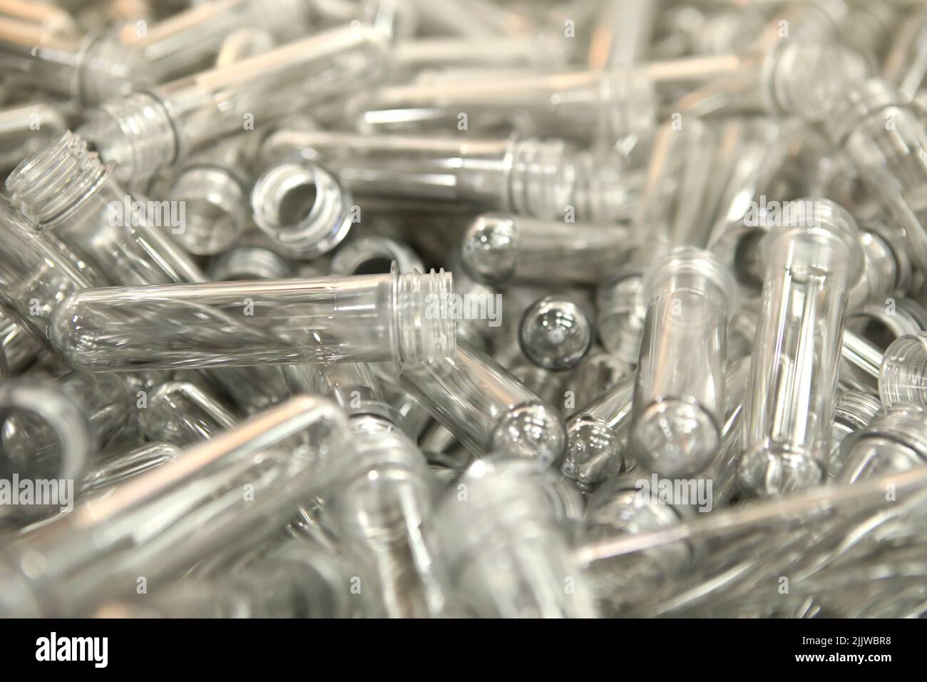 Preform for the manufacture of plastic bottles. Lots of bottles Stock ...