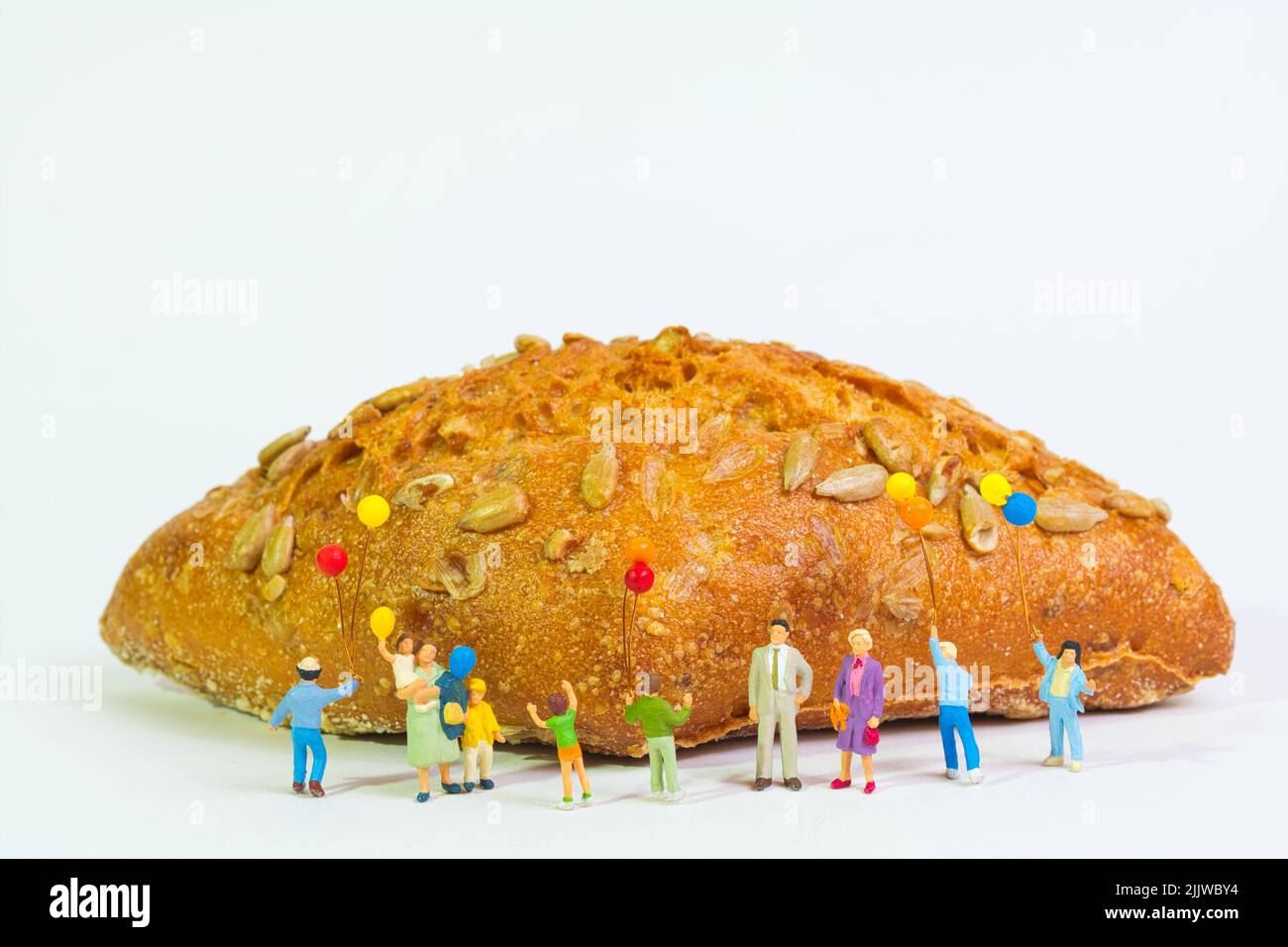 happy family with colorful balloons stands in front of a freshly baked ...