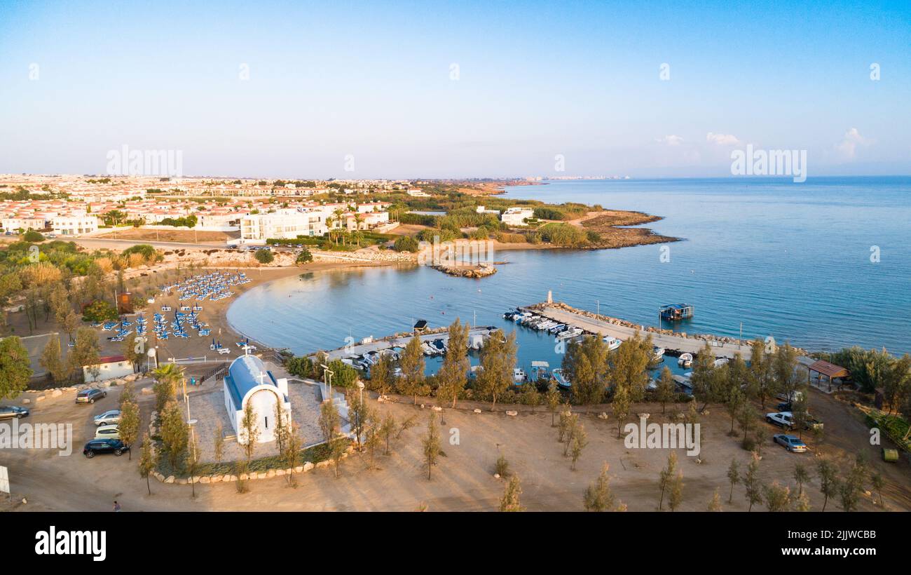Aerial view of coastline sunset and landmark white washed chapel at ...