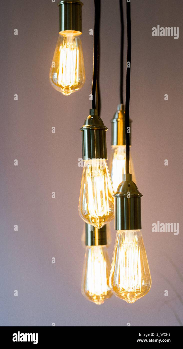 A vertical shot of glowing lamps in white background Stock Photo - Alamy