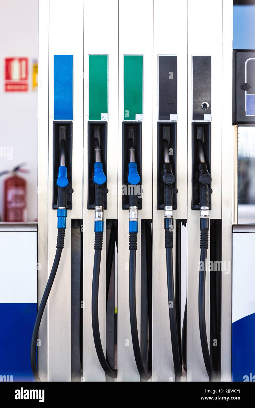 Five black and blue fuel hoses at a gas station. Concept of gasoline ...