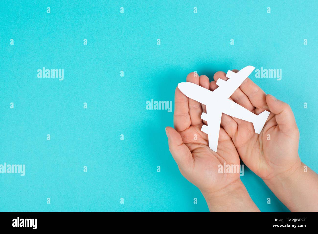 Holding an airplane in the hands, taking a flight, planning a vacation ...