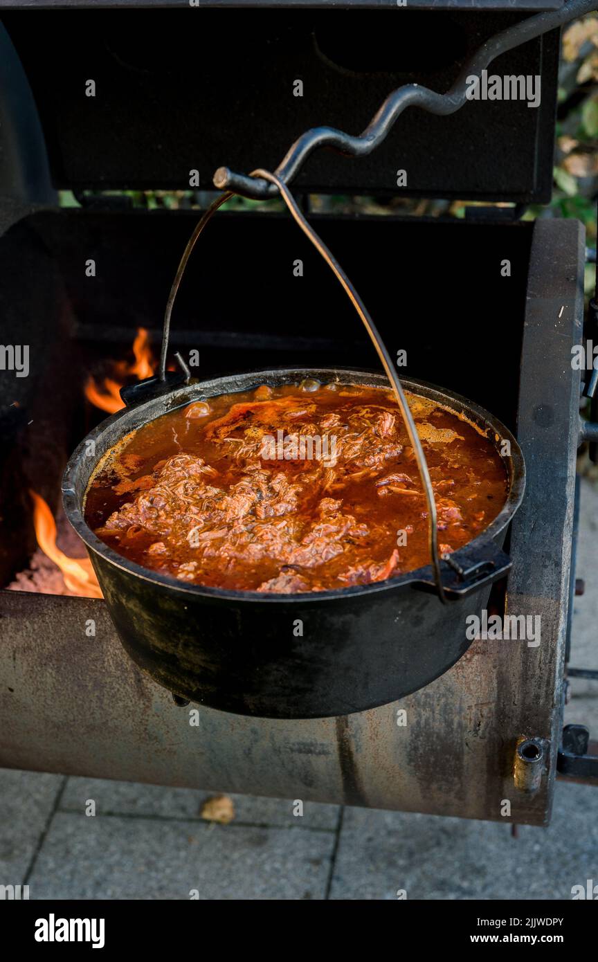 A vertical shot of a meat sauce in a pot on a smoker Stock Photo - Alamy