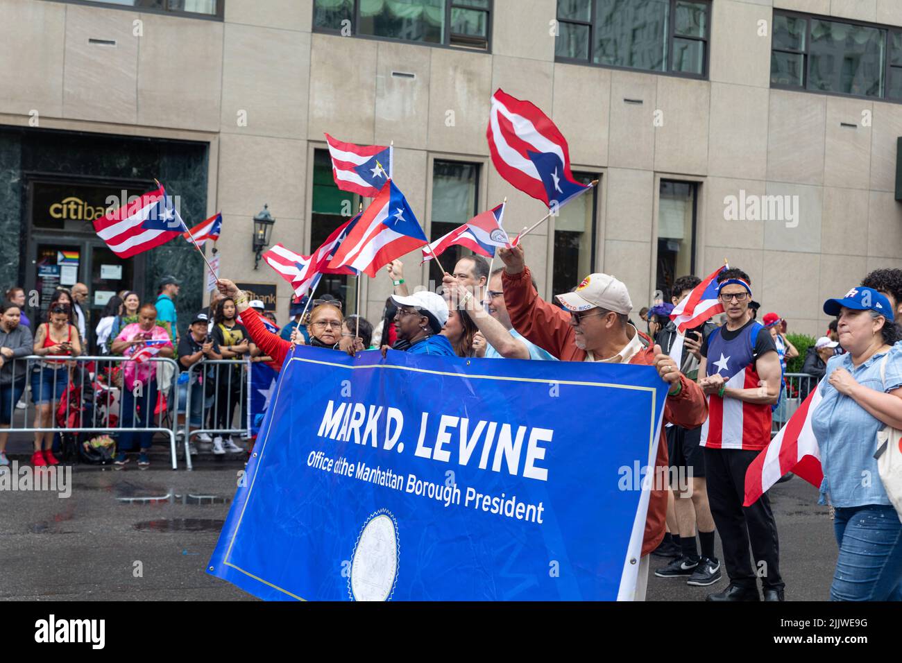 People celebrating the Puerto Rican Day Parade in New York City holding ...