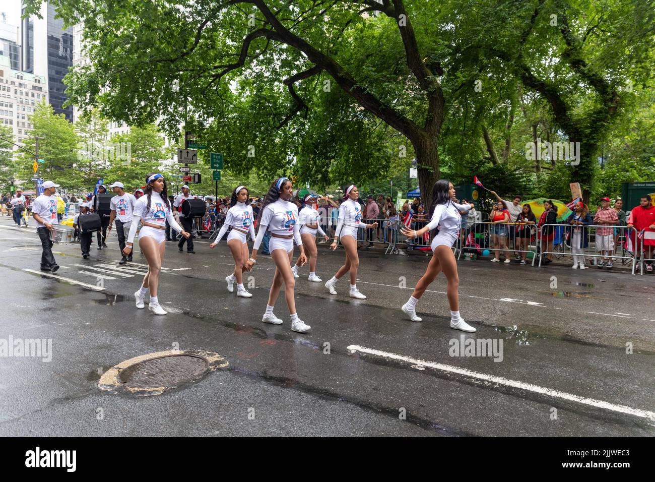 Excited female dancers in white outfits at the Puerto Rican Day Parade ...