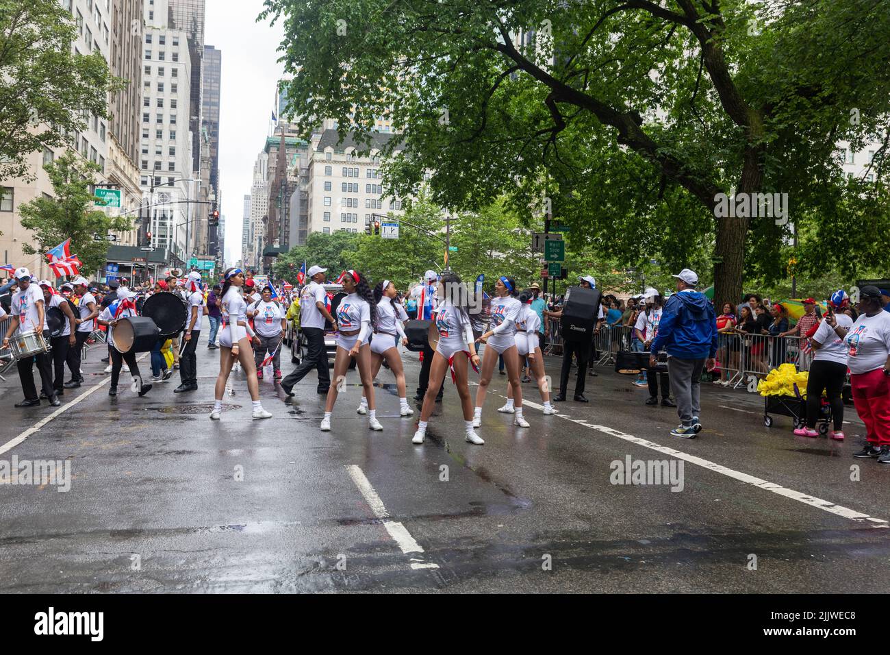 Excited female dancers in white outfits at the Puerto Rican Day Parade ...