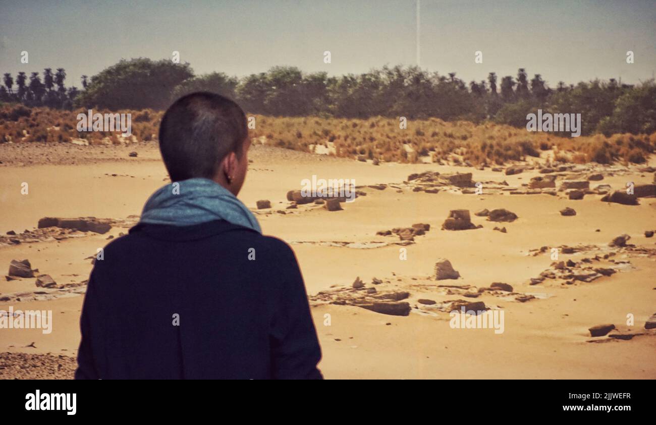 A lonely male standing and looking into the distance in a desert Stock ...