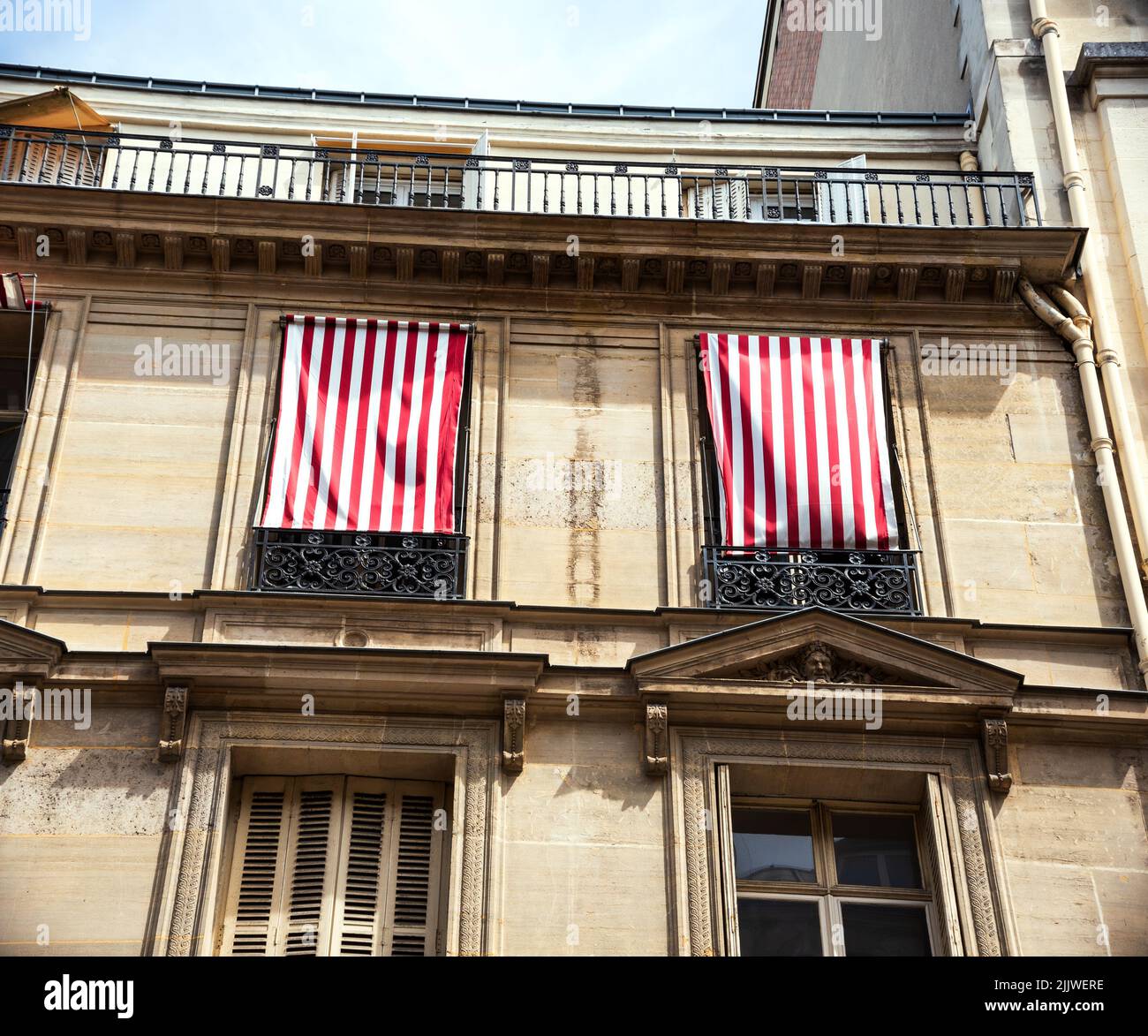 Summer in Paris. Striped sun shade over window. Architectural detail ...