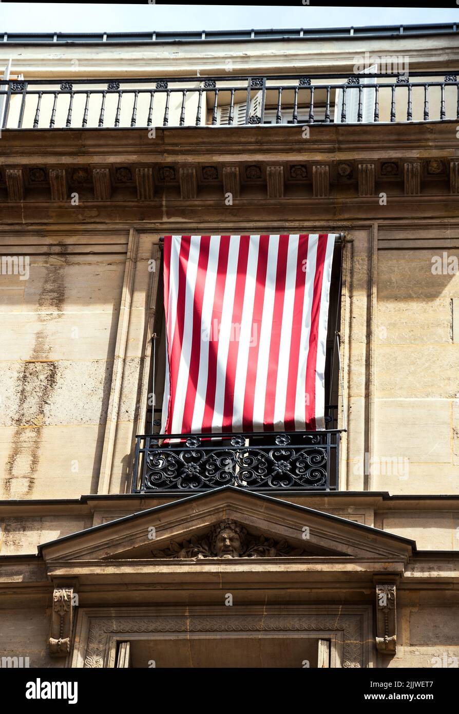 Summer in Paris. Striped sun shade over window. Architectural detail ...