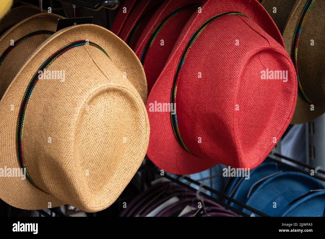Different colorful wicker hats for sale. Stylish fashion background ...