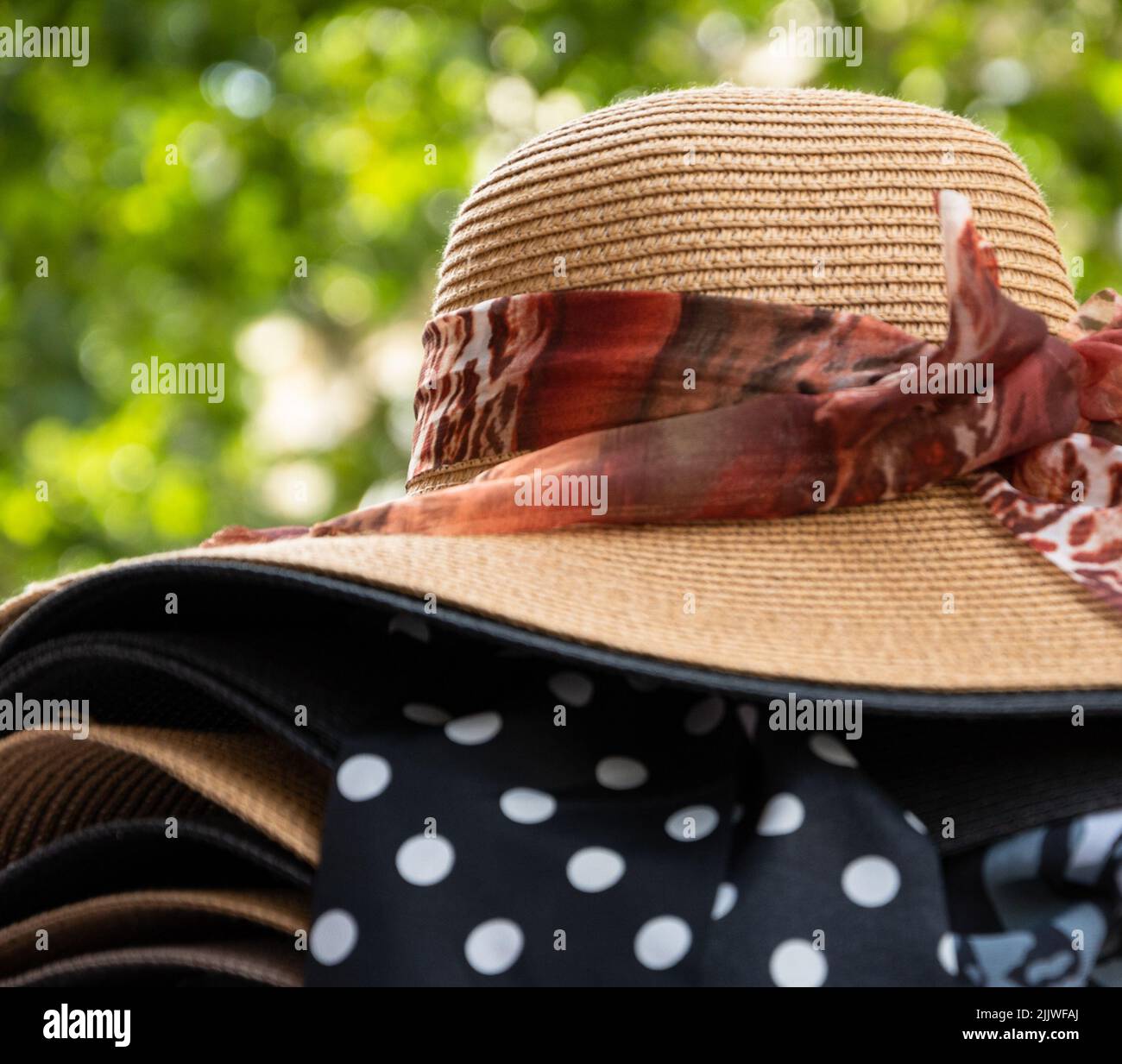 Female wicker hats with different bows for sale and green street at ...
