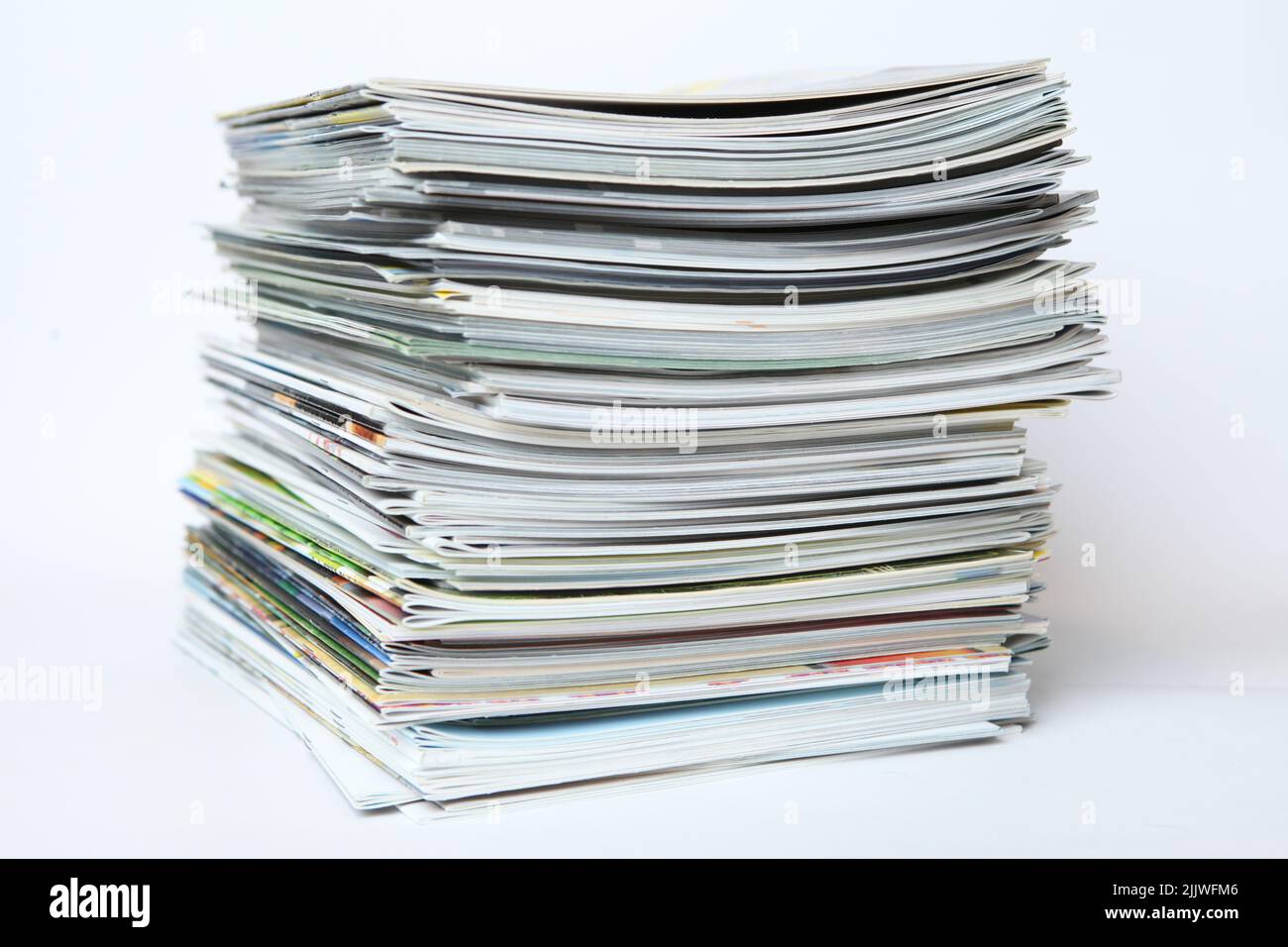 A large stack of printing magazines on a white background. Lots of ...