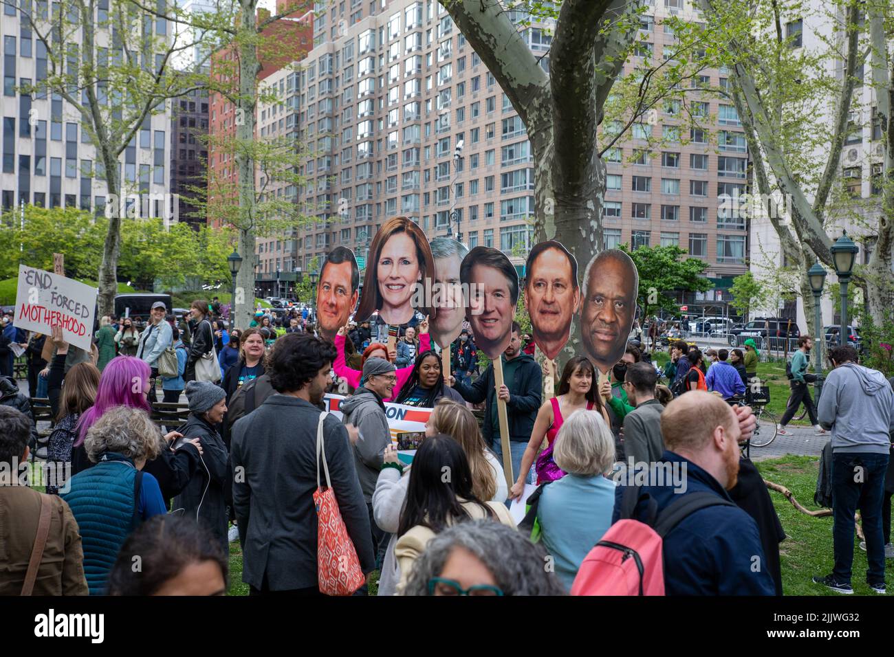 A young female holding a cardboard sign at Foley Square, New York, USA ...