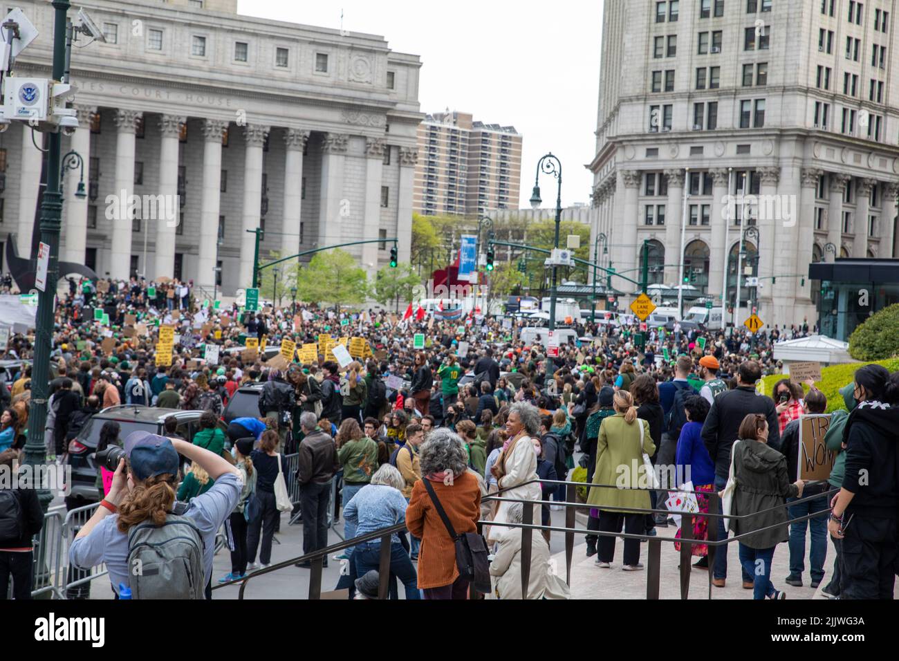 A young female holding a cardboard sign at Foley Square, New York, NY ...