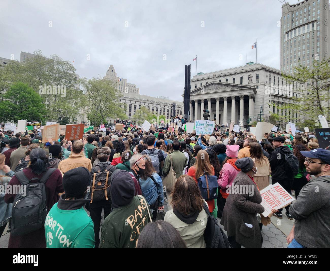 A crowd holding a cardboard sign Foley Square, New York, NY, USA Stock ...