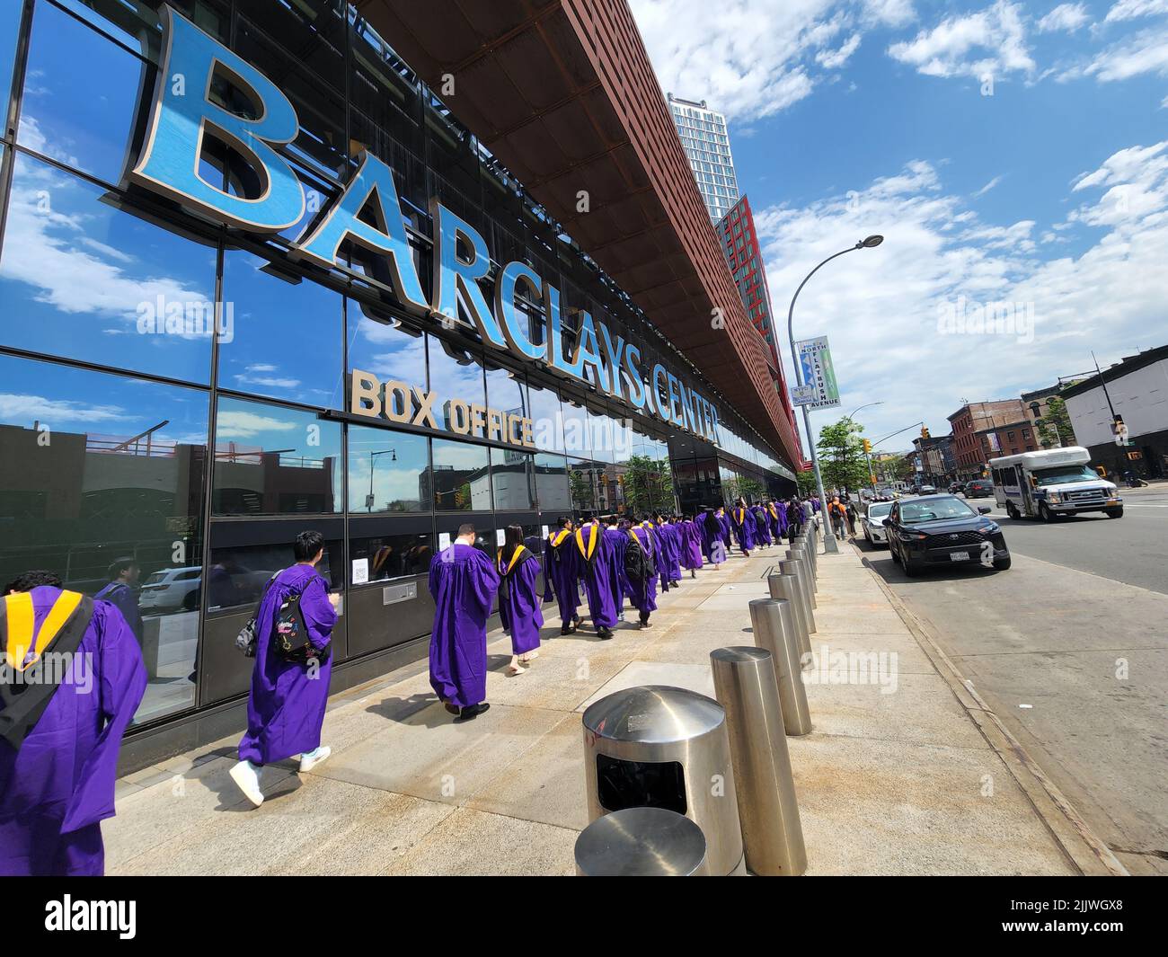 A crowd of graduating students in caps and gowns waiting to get into ...