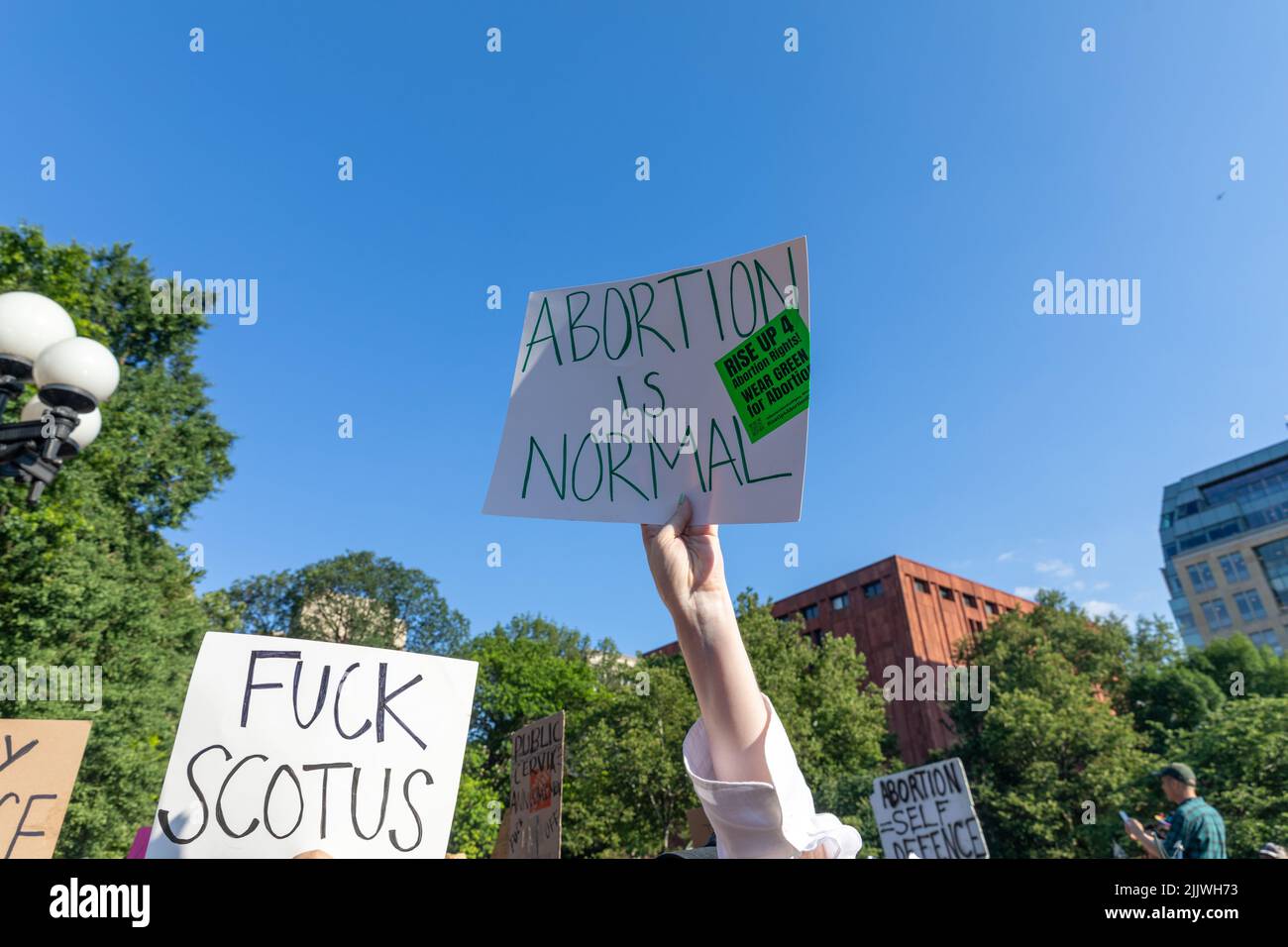 The protesters holding cardboard signs after Supreme Court Overturned ...