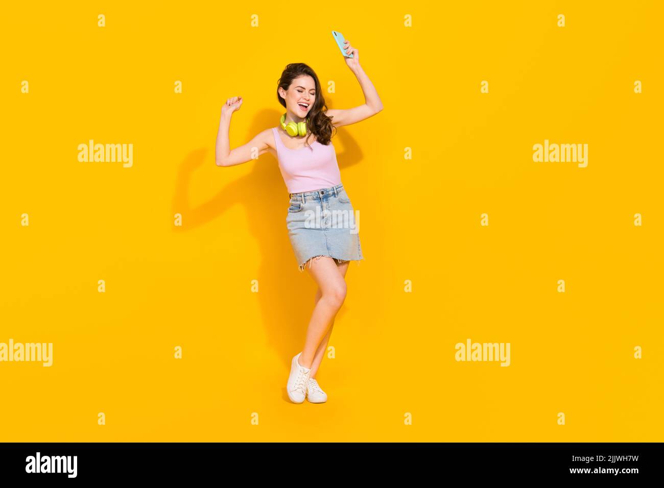 Full body photo of overjoyed satisfied lady hold telephone dancing ...