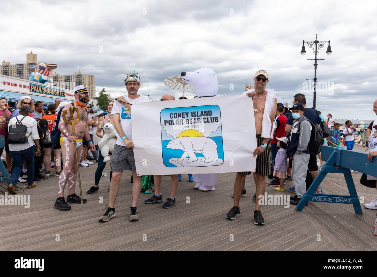 A shot of two men with a poster dedicated to the 40th Annual Mermaid ...