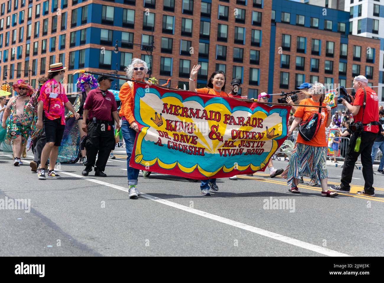 A shot of two women with a poster dedicated to the 40th Annual Mermaid ...
