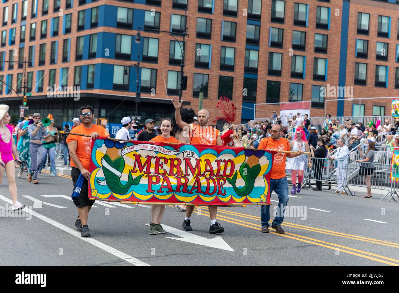 A shot of people with a poster dedicated to the 40th Annual Mermaid ...