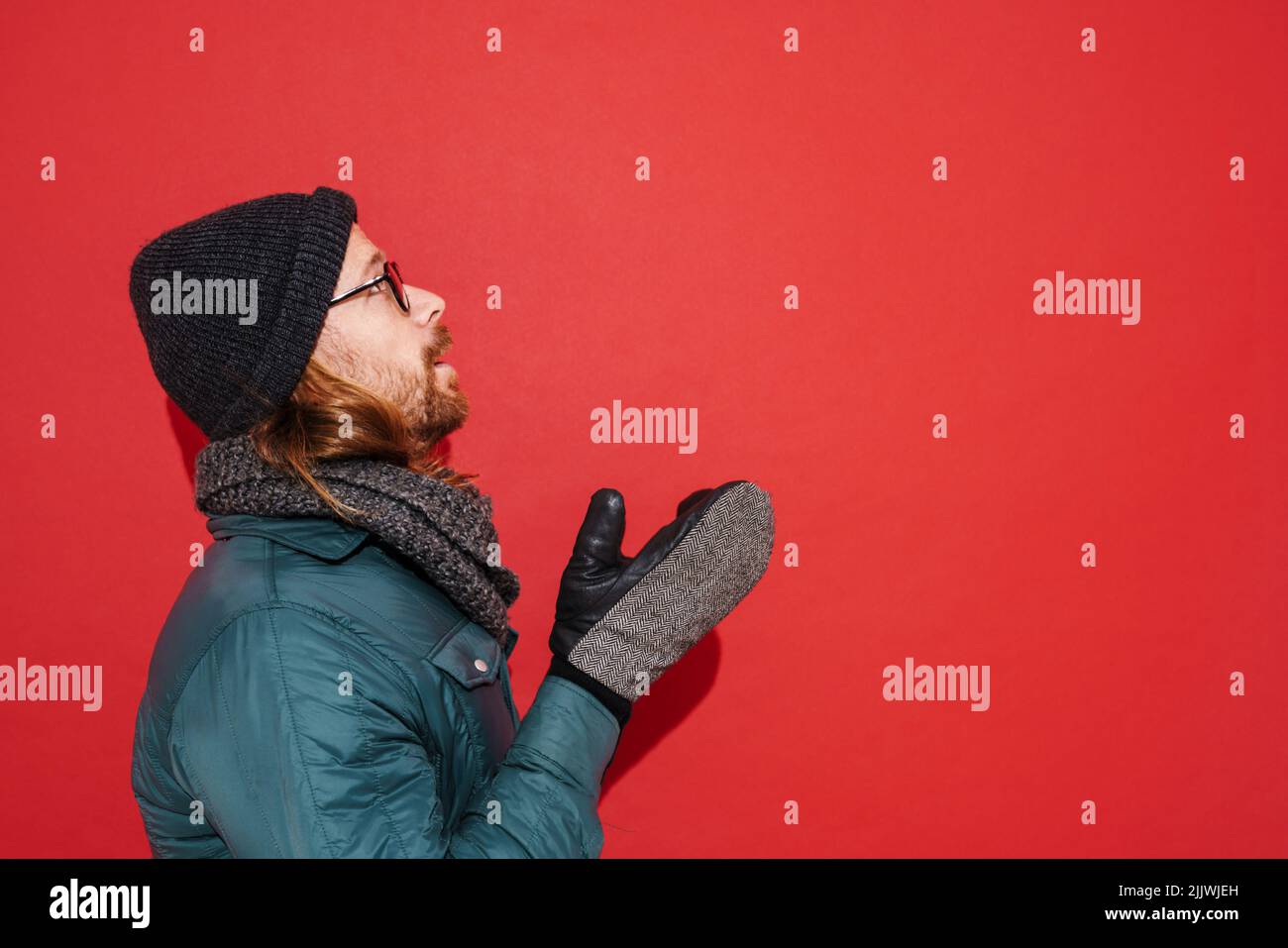 Ginger man wearing hat and jacket trembling and feeling cold isolated ...