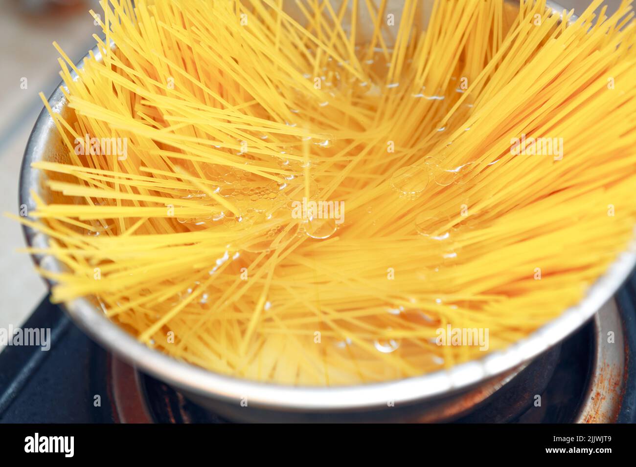 Pasta in boiling water . Preparing an Italian dinner . Macaroni food ...