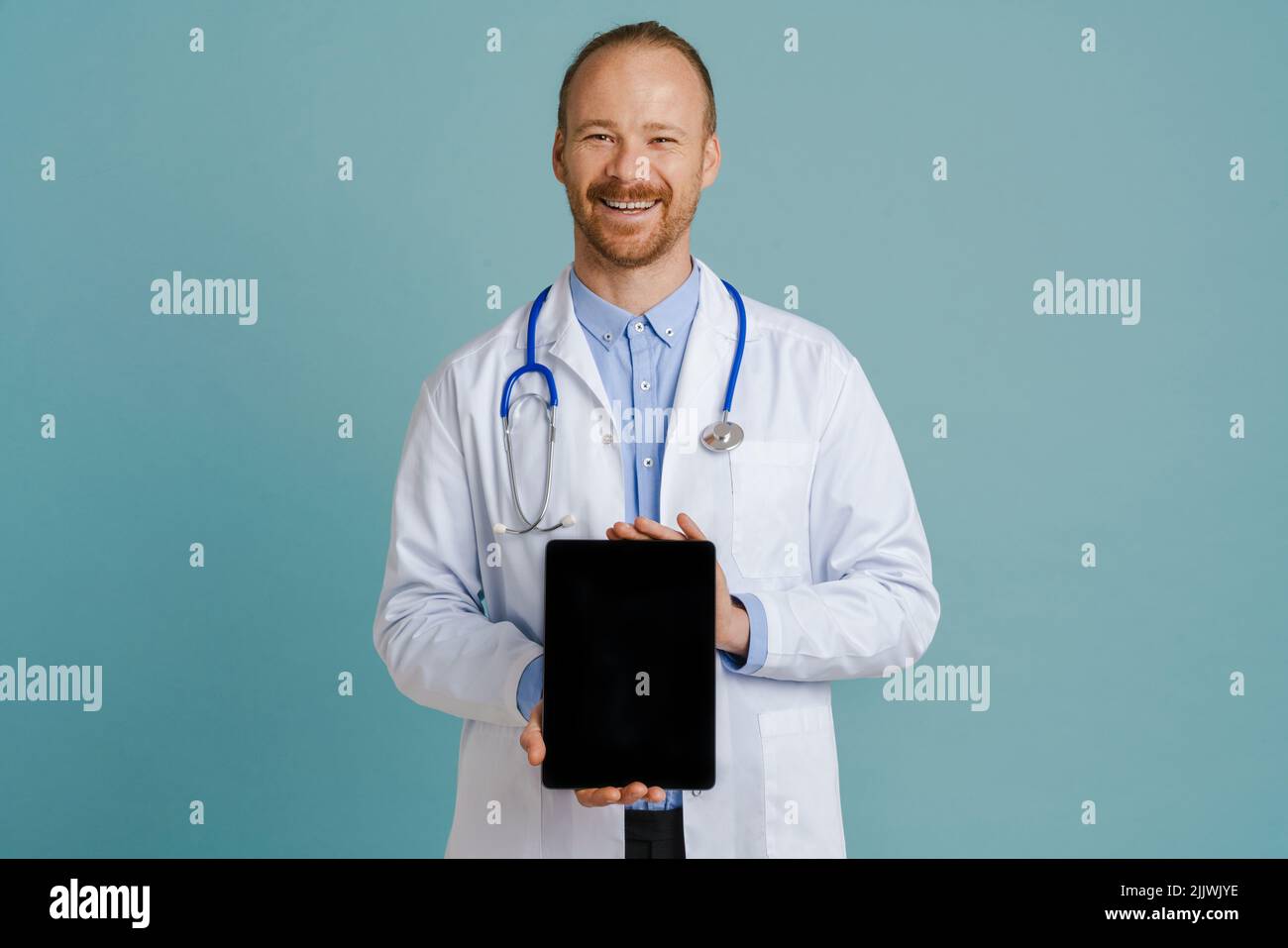 White male doctor wearing lab coat showing tablet computer isolated ...