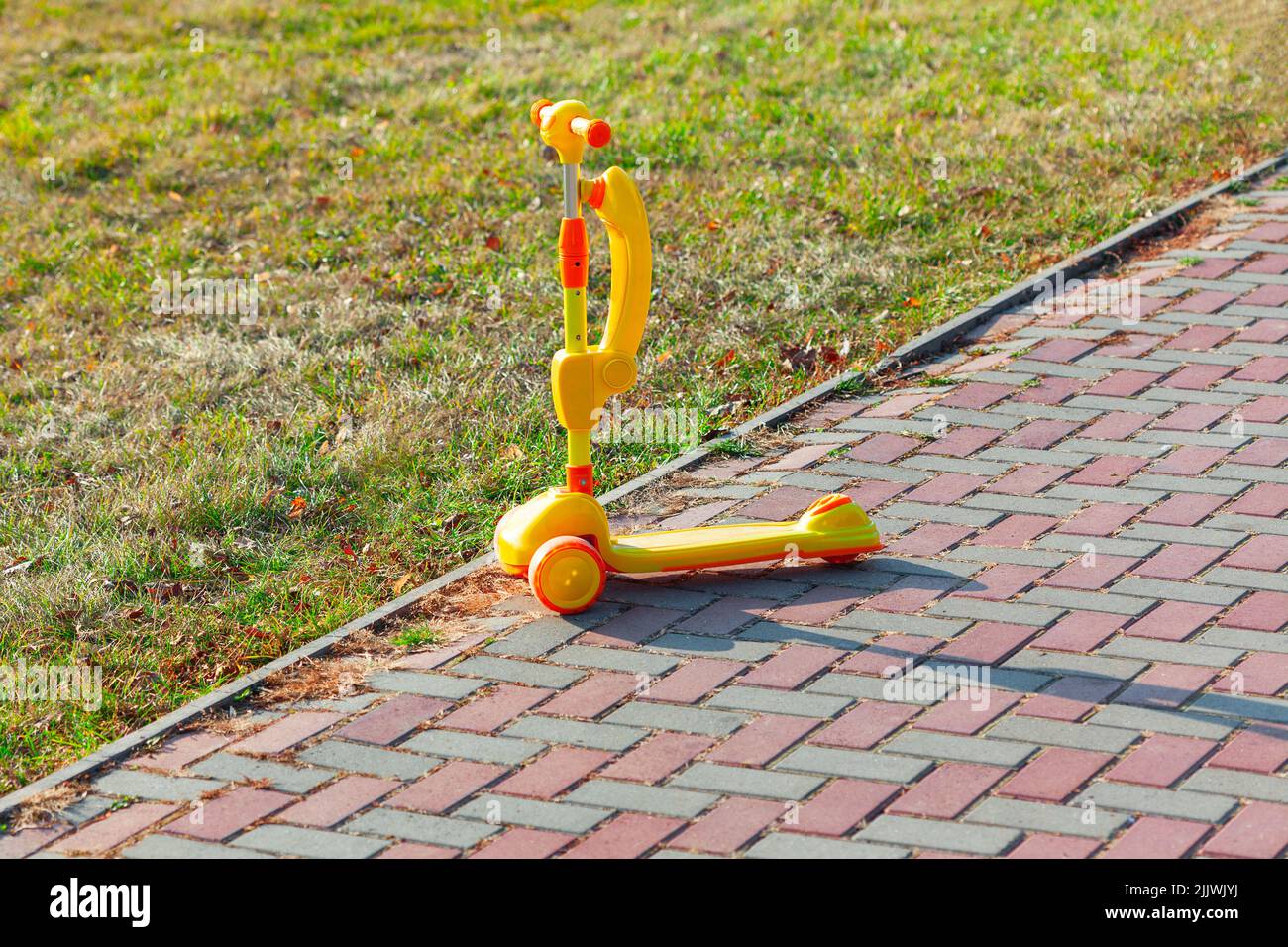 Scooter for children at the pavement . Kids scooter in the park Stock ...