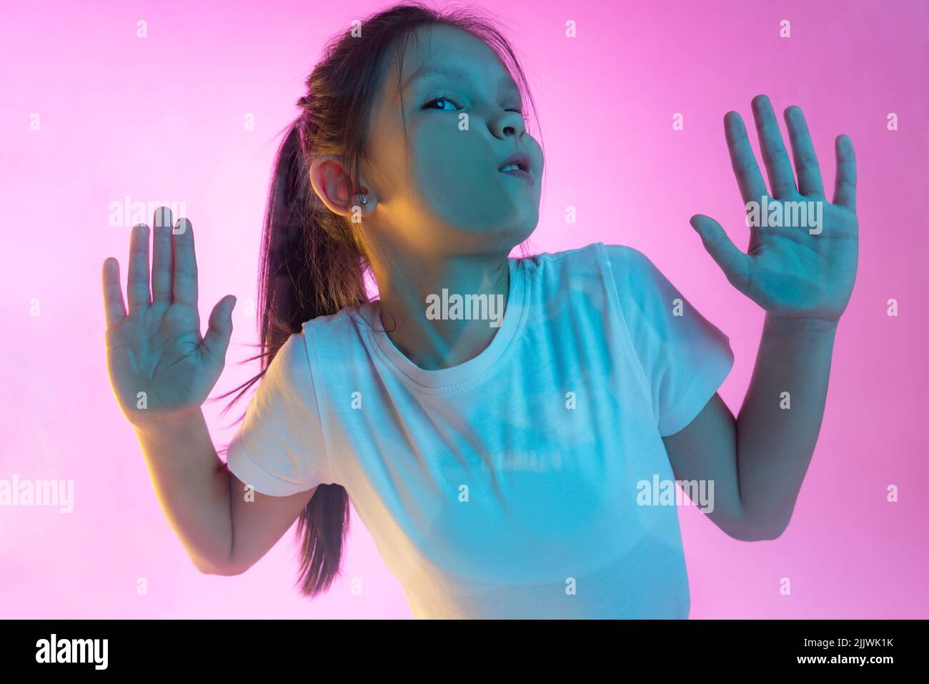 Close-up girl, kid leaning against transparent glass by cheek isolated ...
