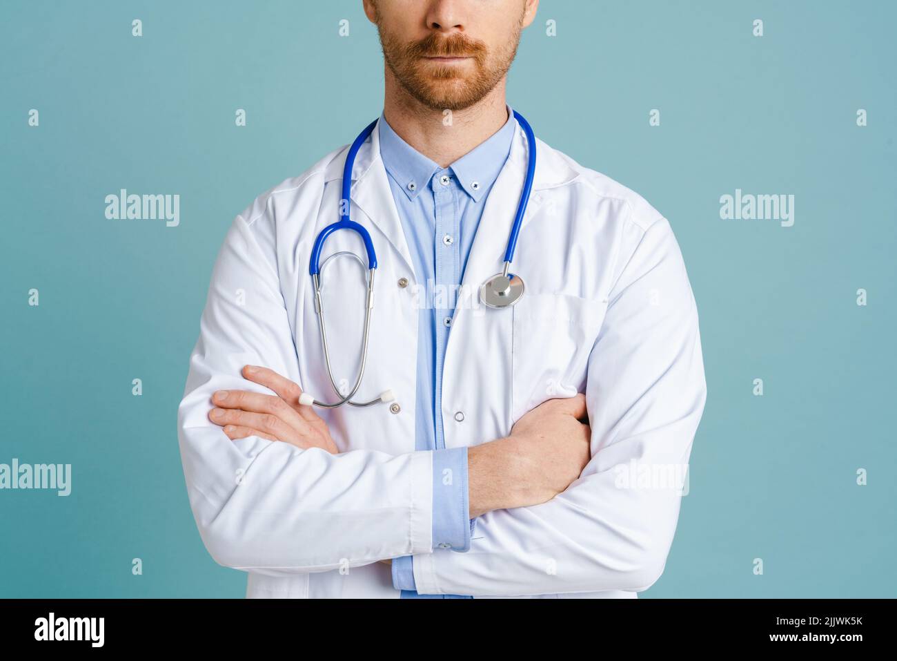 White male doctor wearing lab coat posing with stethoscope isolated ...