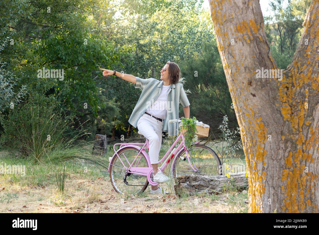 Happy young man happily pointing something in the distancewith flare in ...