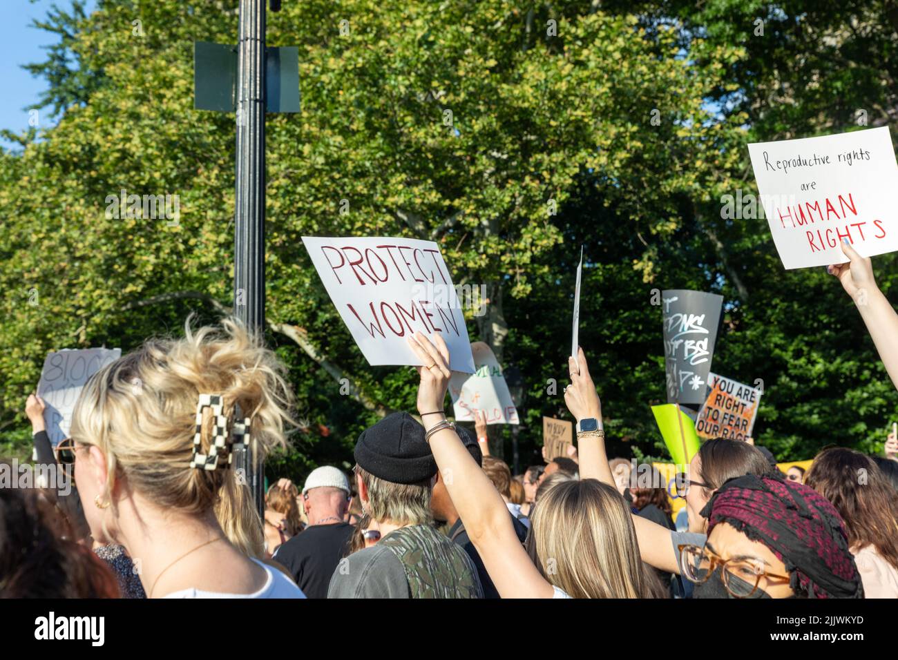 A crowd of protesters holding cardboard signs after Supreme Court ...