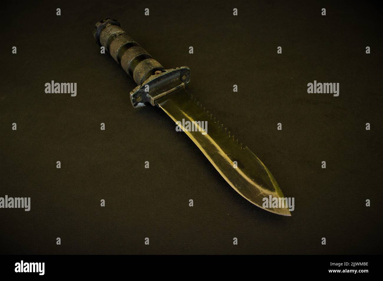 dark black military knife on black background Stock Photo - Alamy