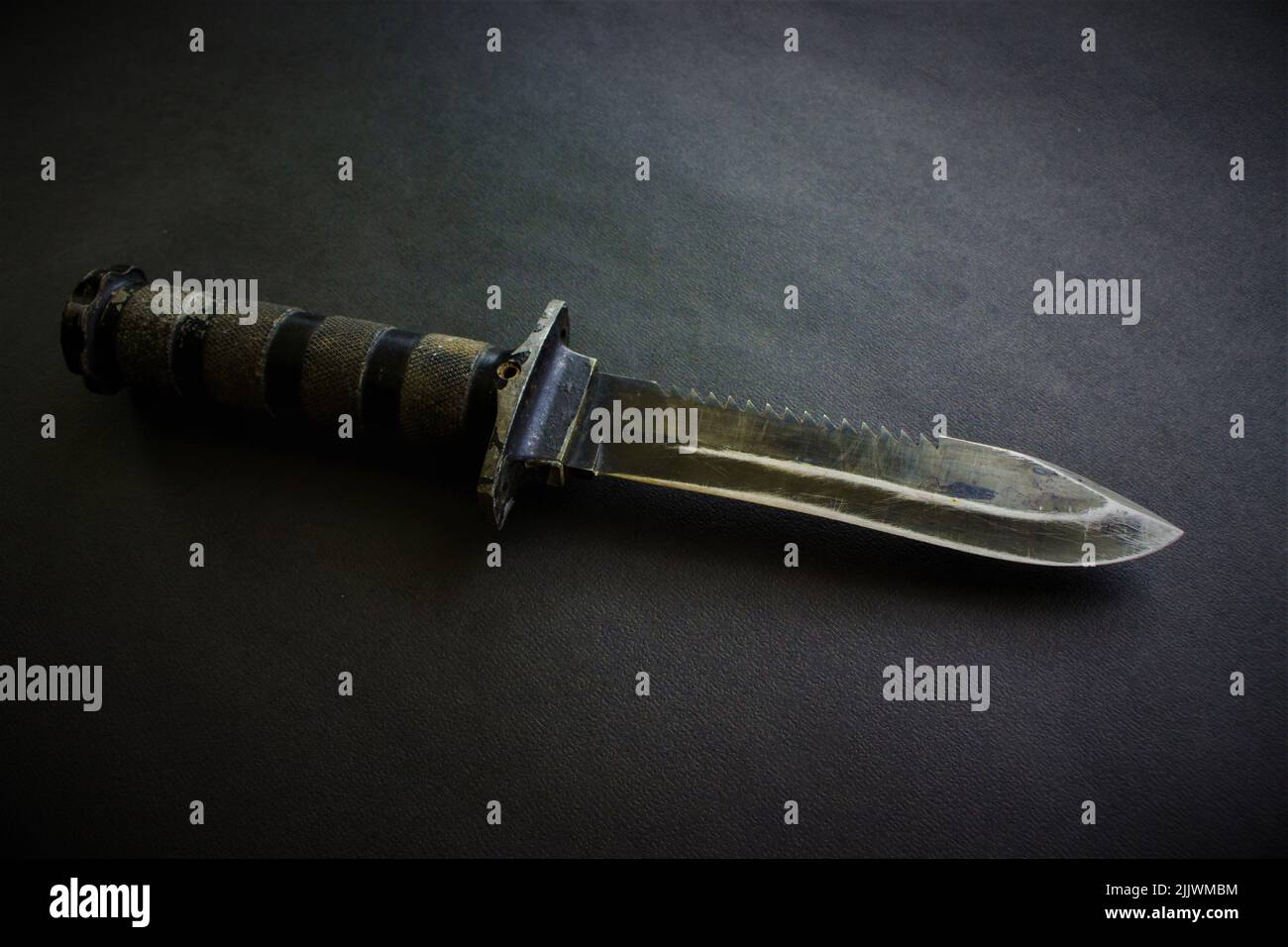 dark black military knife on black background Stock Photo - Alamy